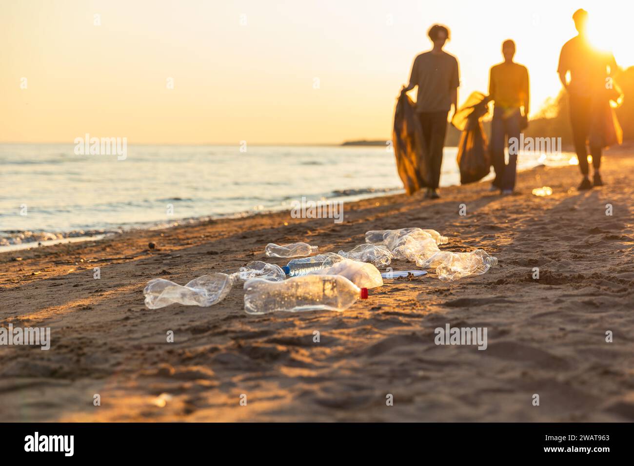Earth day. Volunteers activists team collects garbage cleaning of beach ...