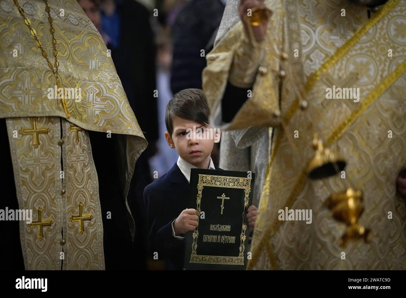 A boy and Russian Orthodox Church priests take the part during the ...