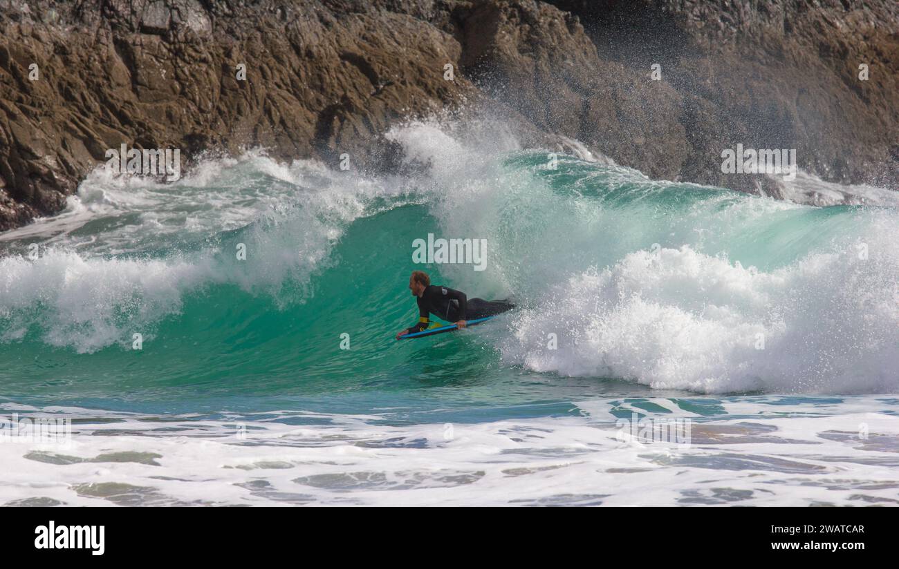 Body boarding or short boarding, riding a wave; Kynance Cove, Cornwall ...