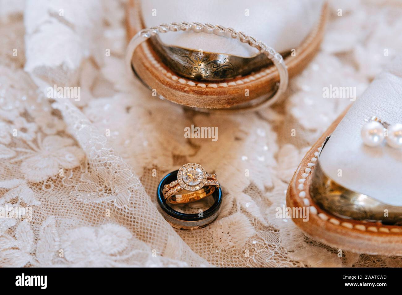 Gold wedding bands, two of them in a ring case, sitting side by side on ...