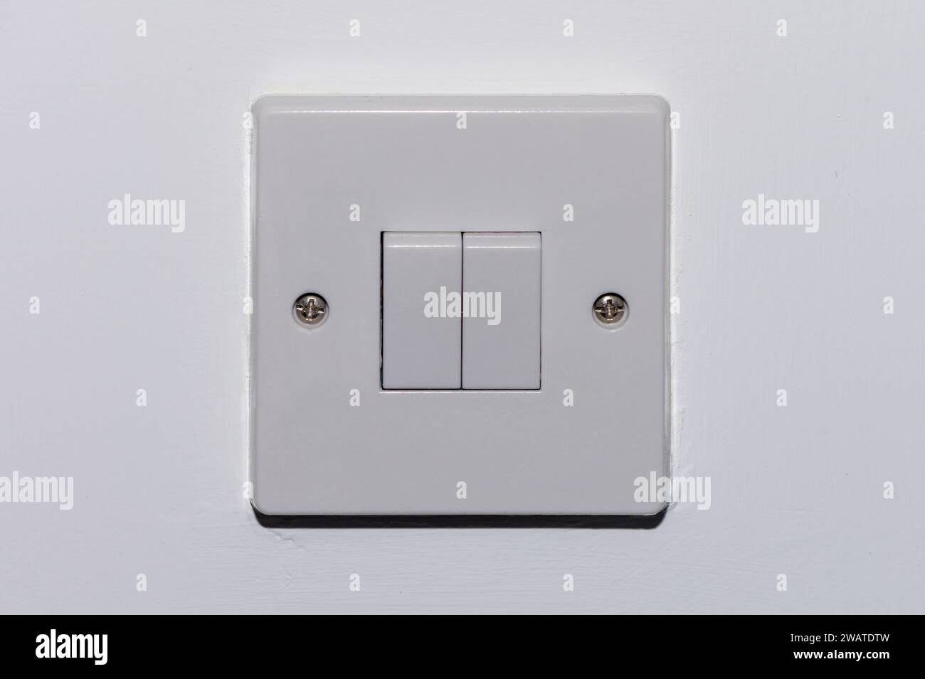 two button switch on a white wall 1 Stock Photo - Alamy