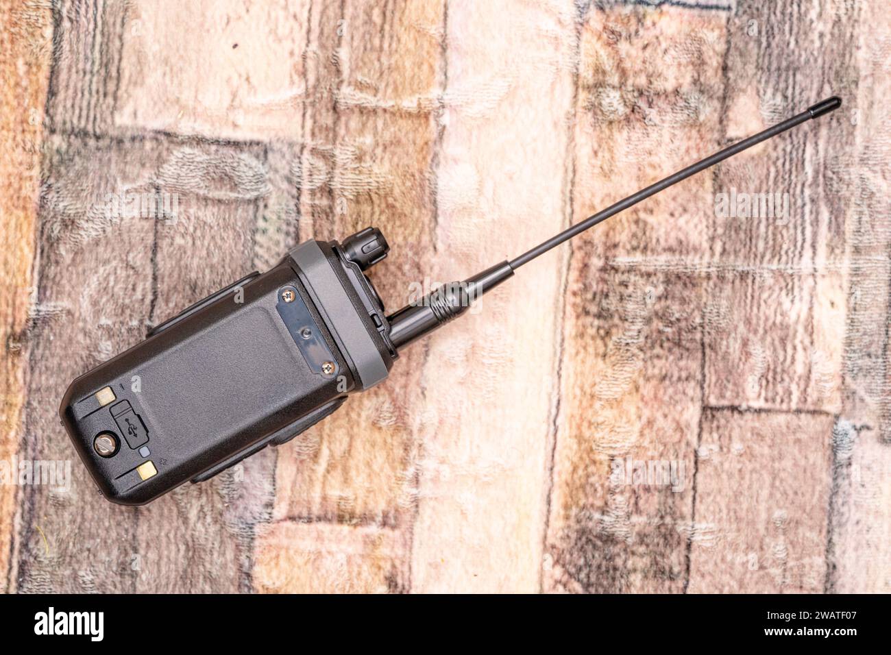 Baofeng BF-21 portable amateur radio on its back under a fabric surface ...