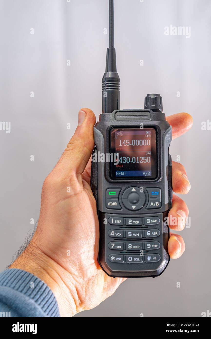 amateur radio walkie talkie portable triband held in the hand of a ...
