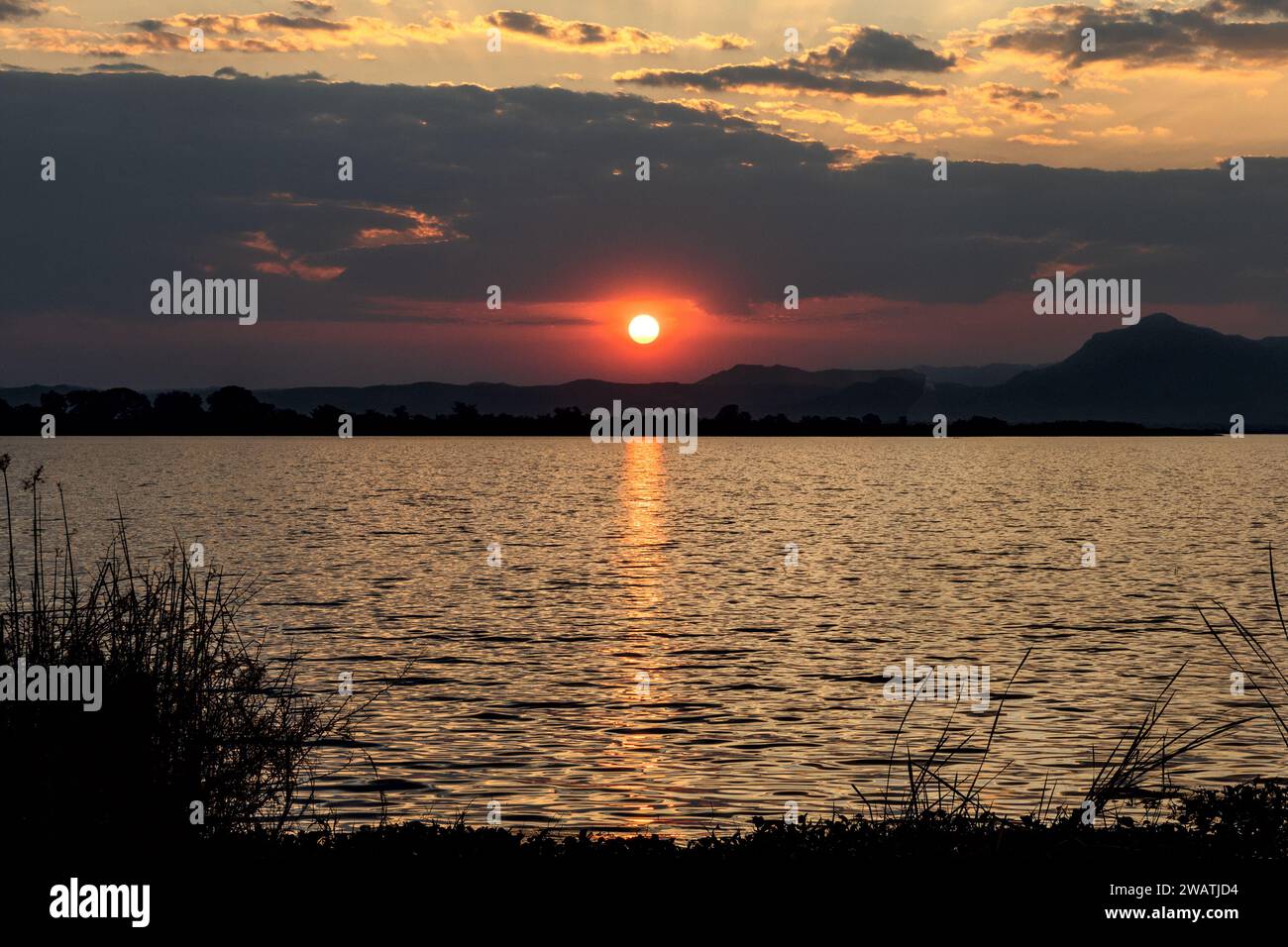 Dusk, sun & clouds, Shire river, Liwonde National Park, Malawi Stock ...