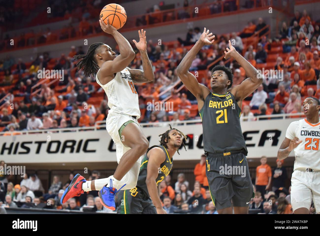 Oklahoma State guard Javon Small, left, shoots over Baylor center Yves ...