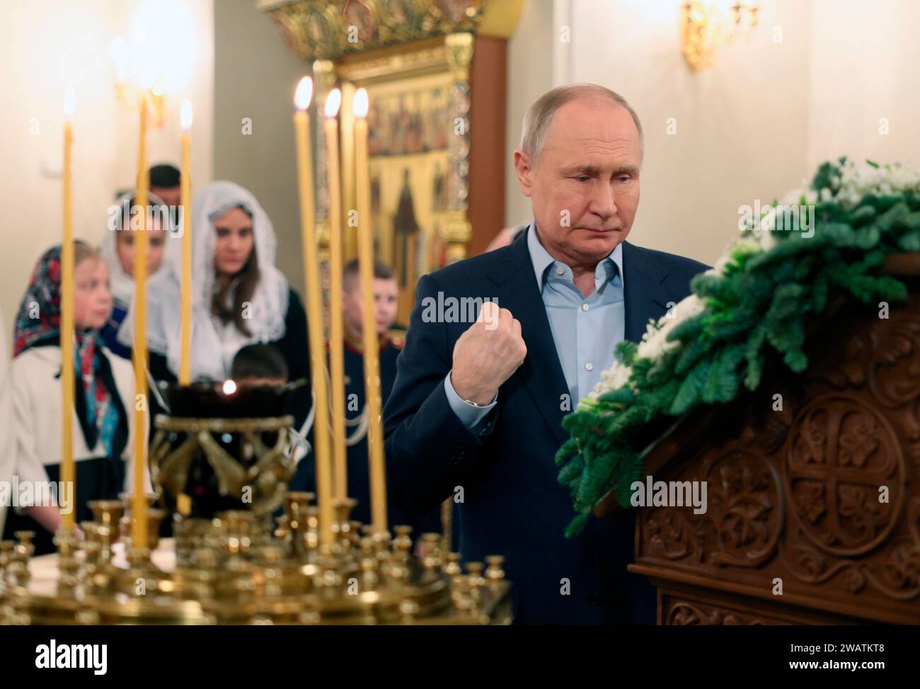 Russian President Vladimir Putin makes the sign of the cross as he ...