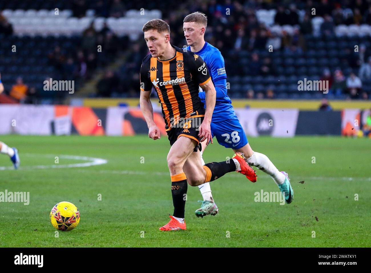 Greg Docherty of Hull City looks for options under pressure from Jay ...