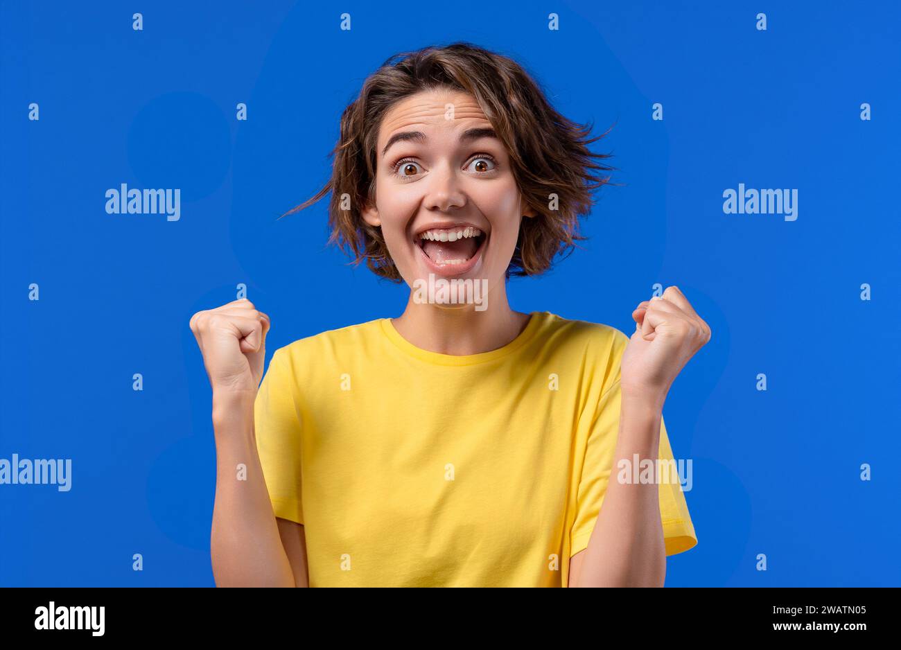 Pretty woman shows triumph yes gesture of victory .Girl happy ...