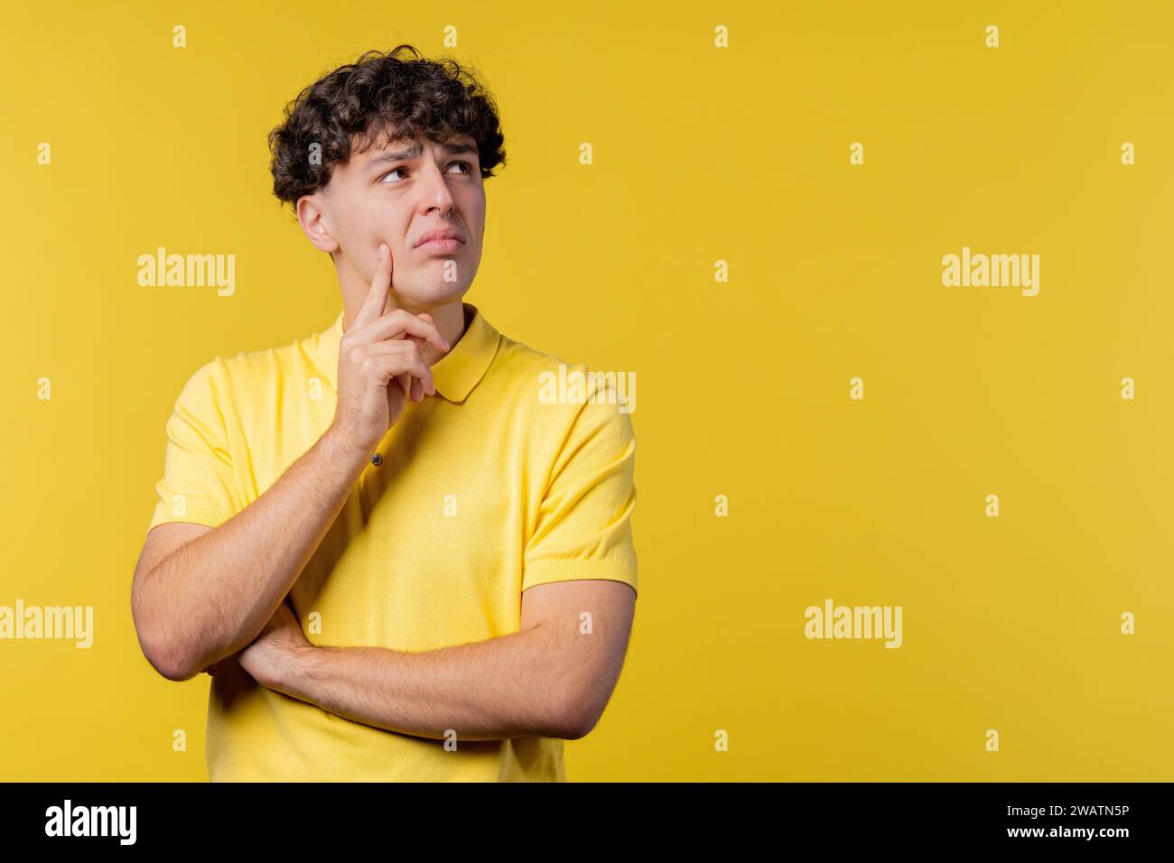 Thinking around man on yellow background. Smart student guy finding ...