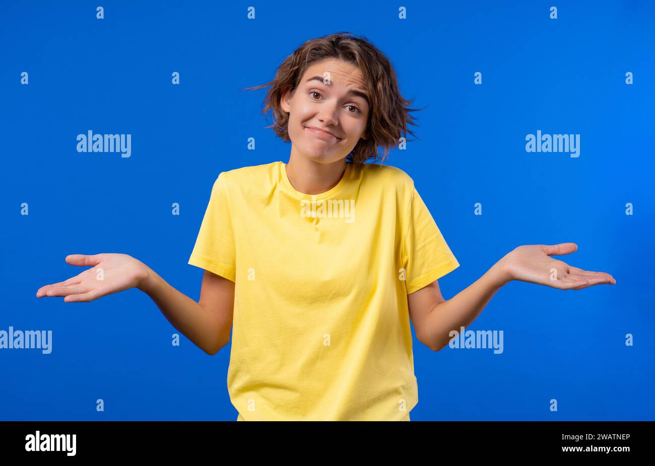 Confused pretty woman, shoulders up - can't help, makes gesture of I ...