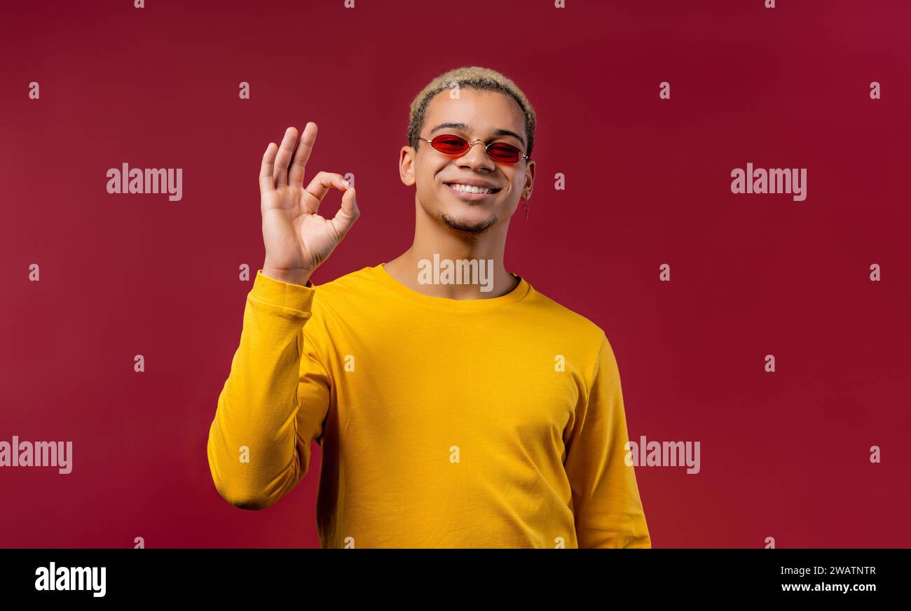 Positive man makes OK hand sign, okay gesture. Happy student guy in ...