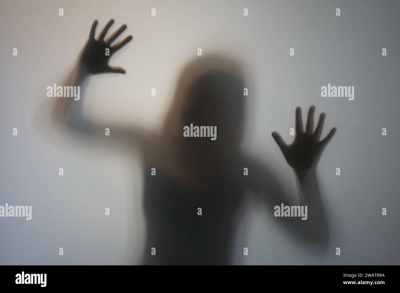 Woman silhouette with raised hands behind frosted glass Stock Photo - Alamy