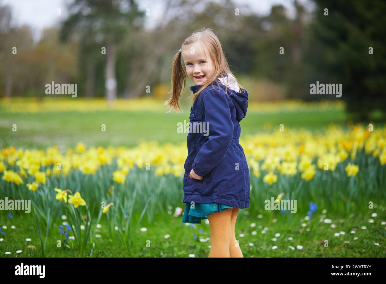 Adorable preschooler girl enjoying nice spring day in park during ...
