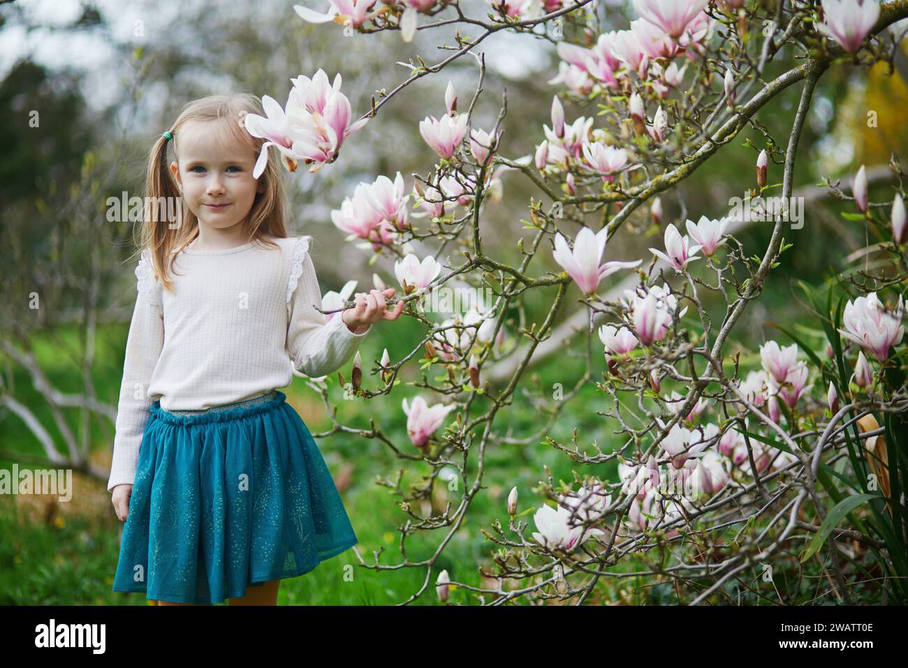 Adorable preschooler girl enjoying nice spring day in park during ...