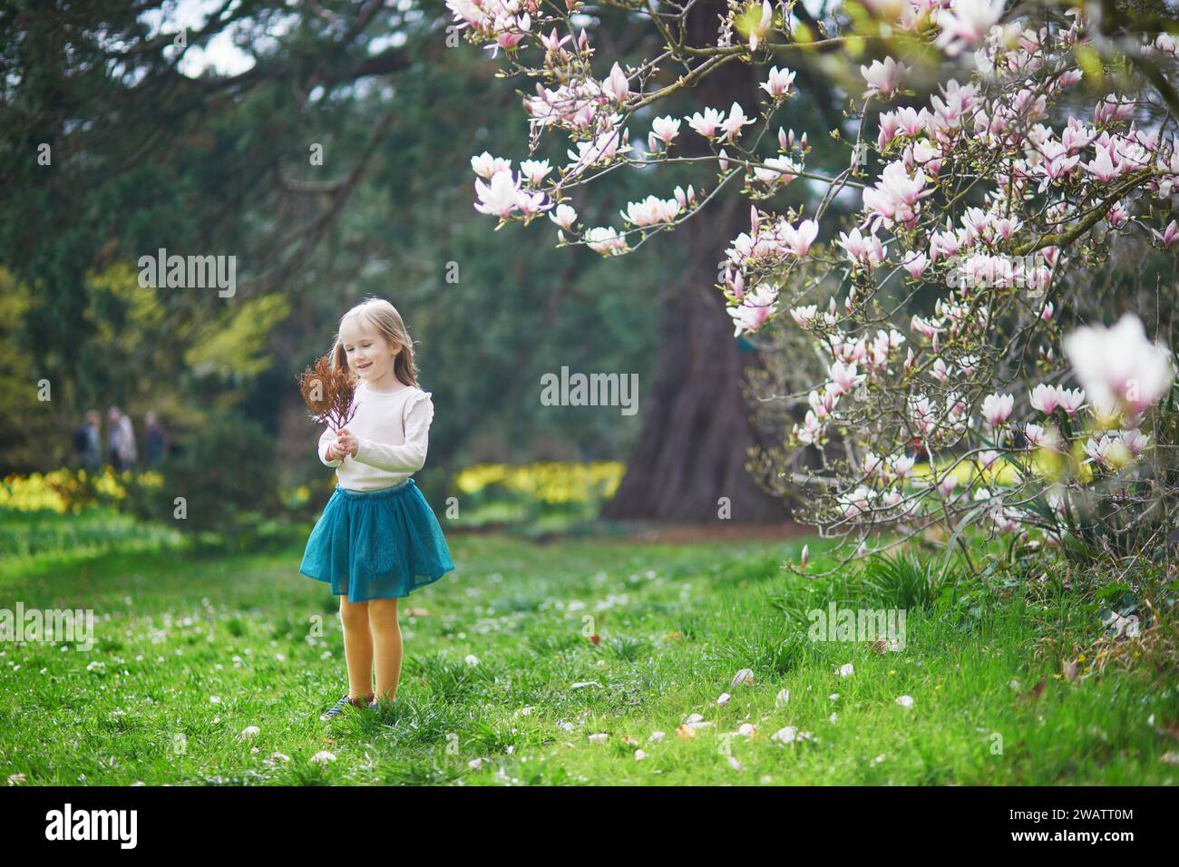 Adorable preschooler girl enjoying nice spring day in park during ...