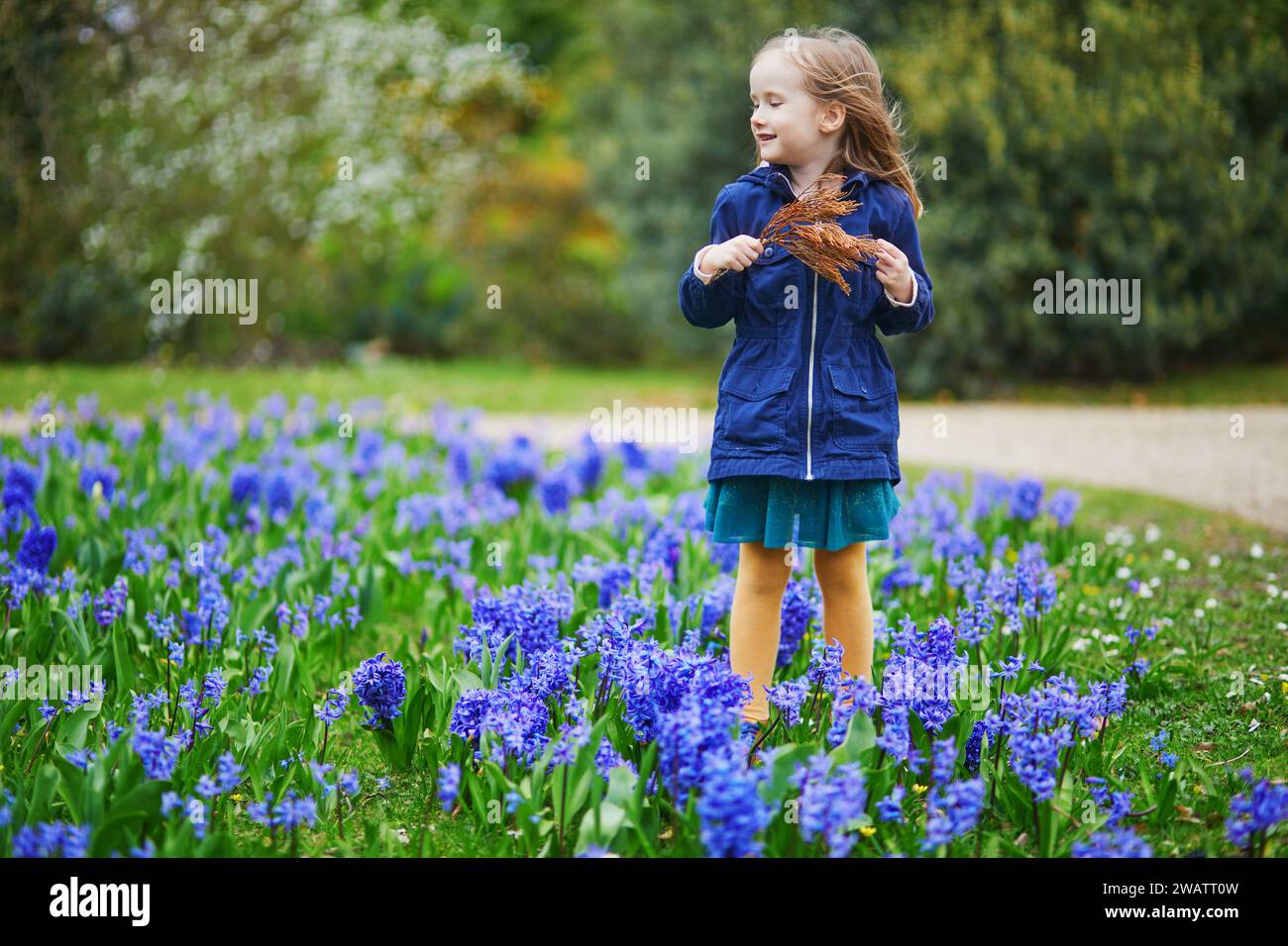 Adorable preschooler girl enjoying nice spring day in park during ...