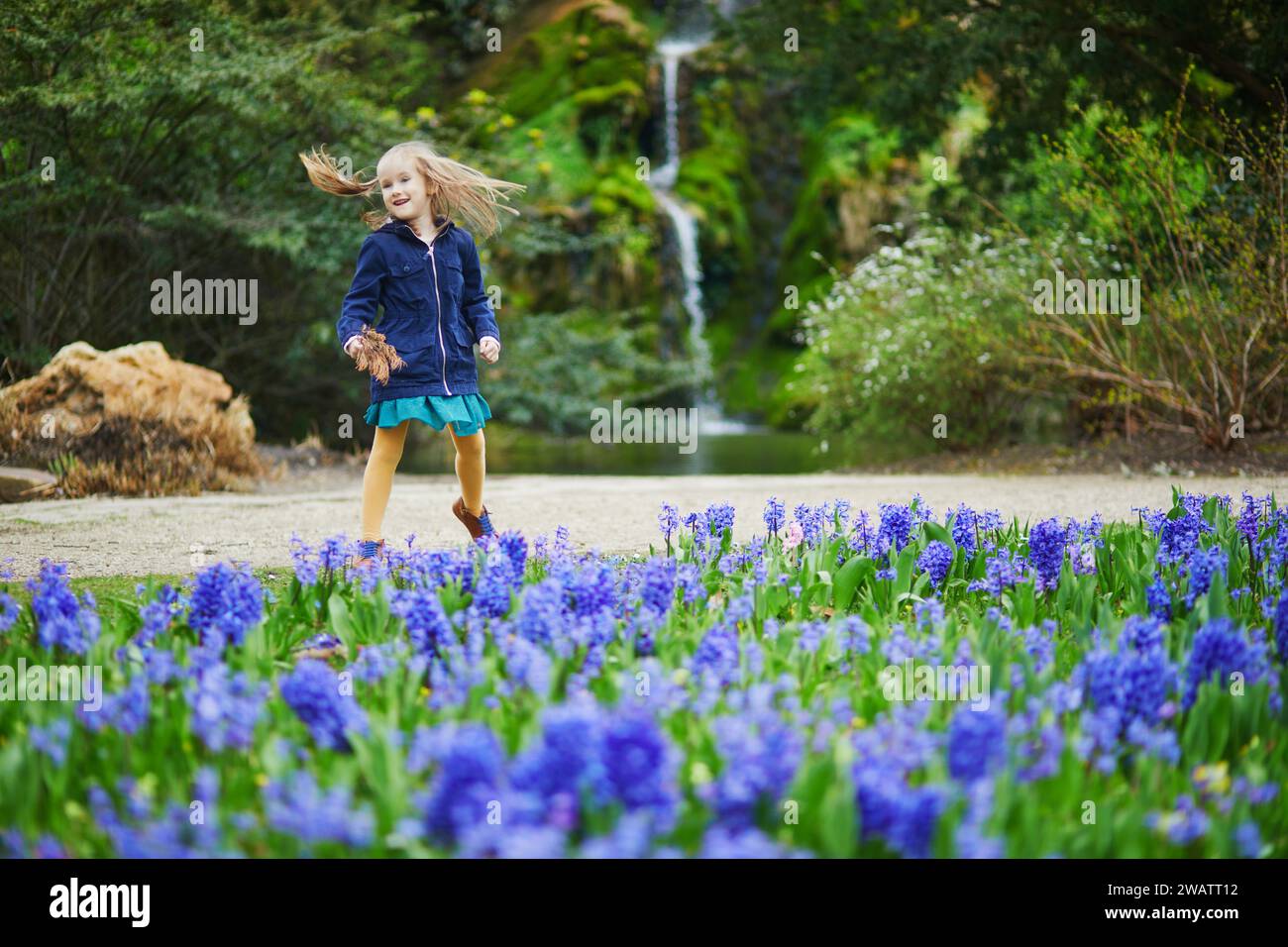 Adorable preschooler girl enjoying nice spring day in park during ...