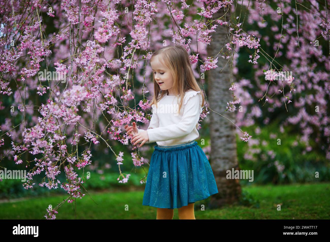 Adorable preschooler girl enjoying nice spring day in park during ...