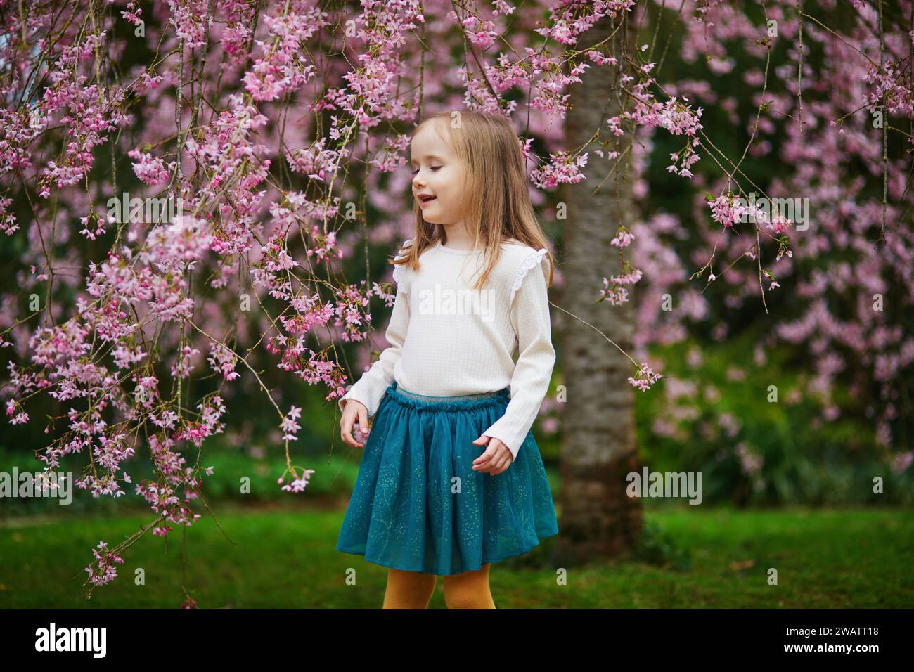 Adorable preschooler girl enjoying nice spring day in park during ...