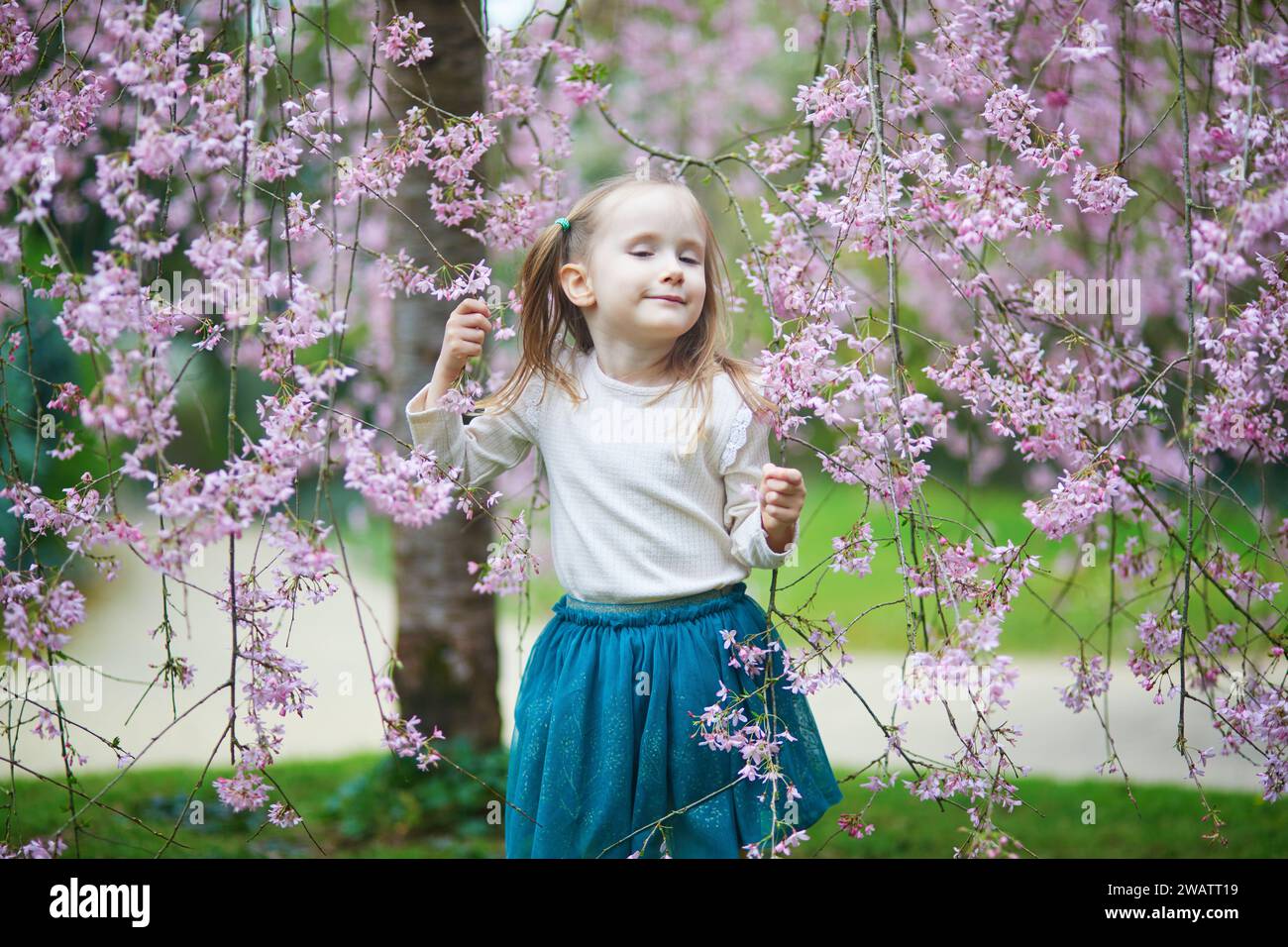 Adorable preschooler girl enjoying nice spring day in park during ...
