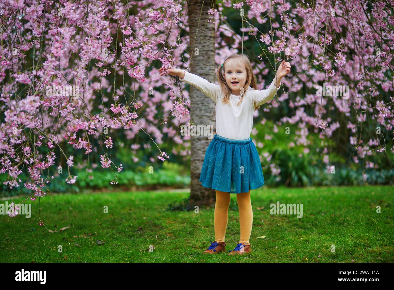 Adorable preschooler girl enjoying nice spring day in park during ...