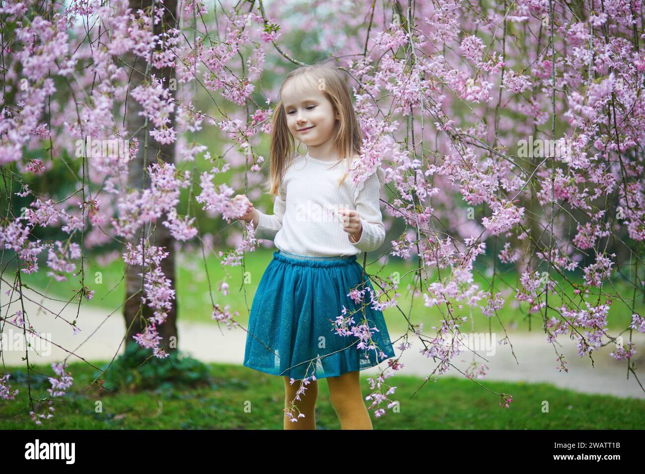 Adorable preschooler girl enjoying nice spring day in park during ...