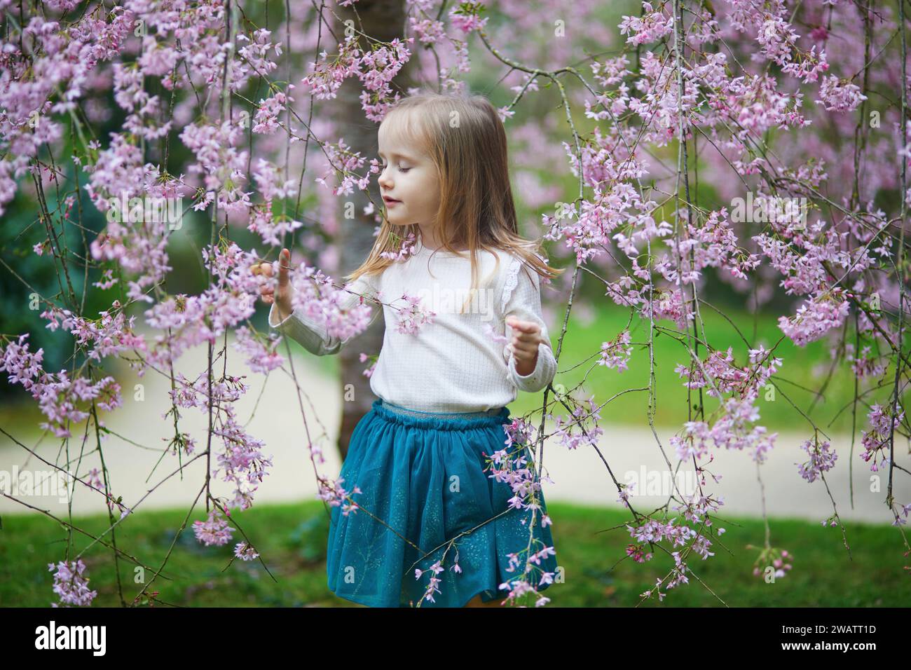 Adorable preschooler girl enjoying nice spring day in park during ...