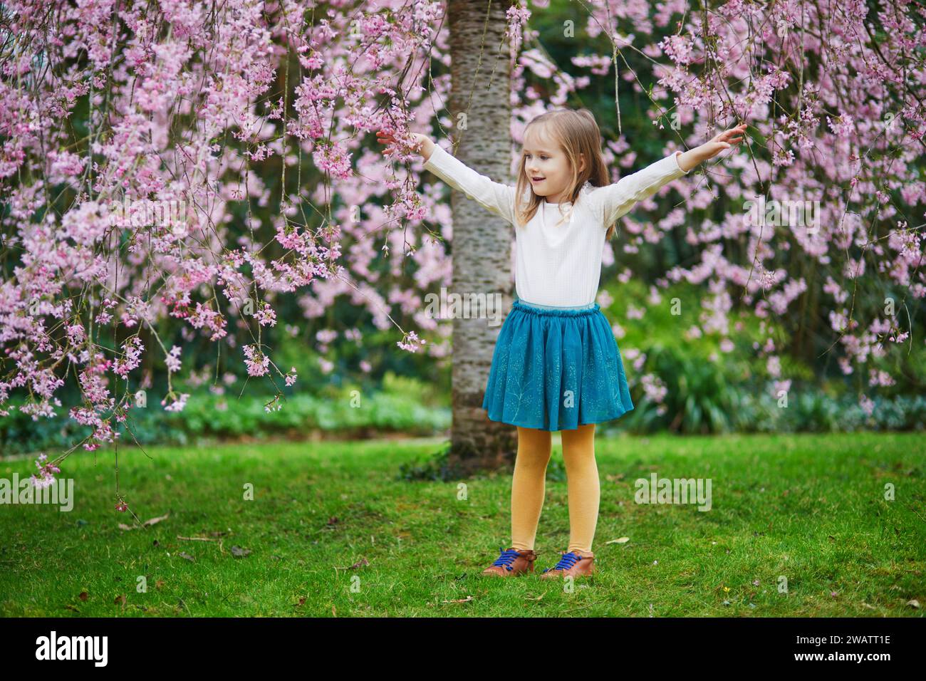 Adorable preschooler girl enjoying nice spring day in park during ...