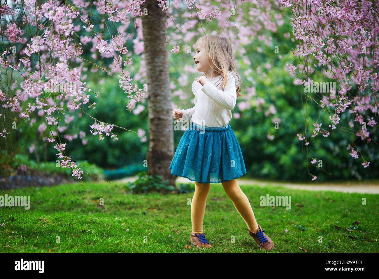 Adorable preschooler girl enjoying nice spring day in park during ...
