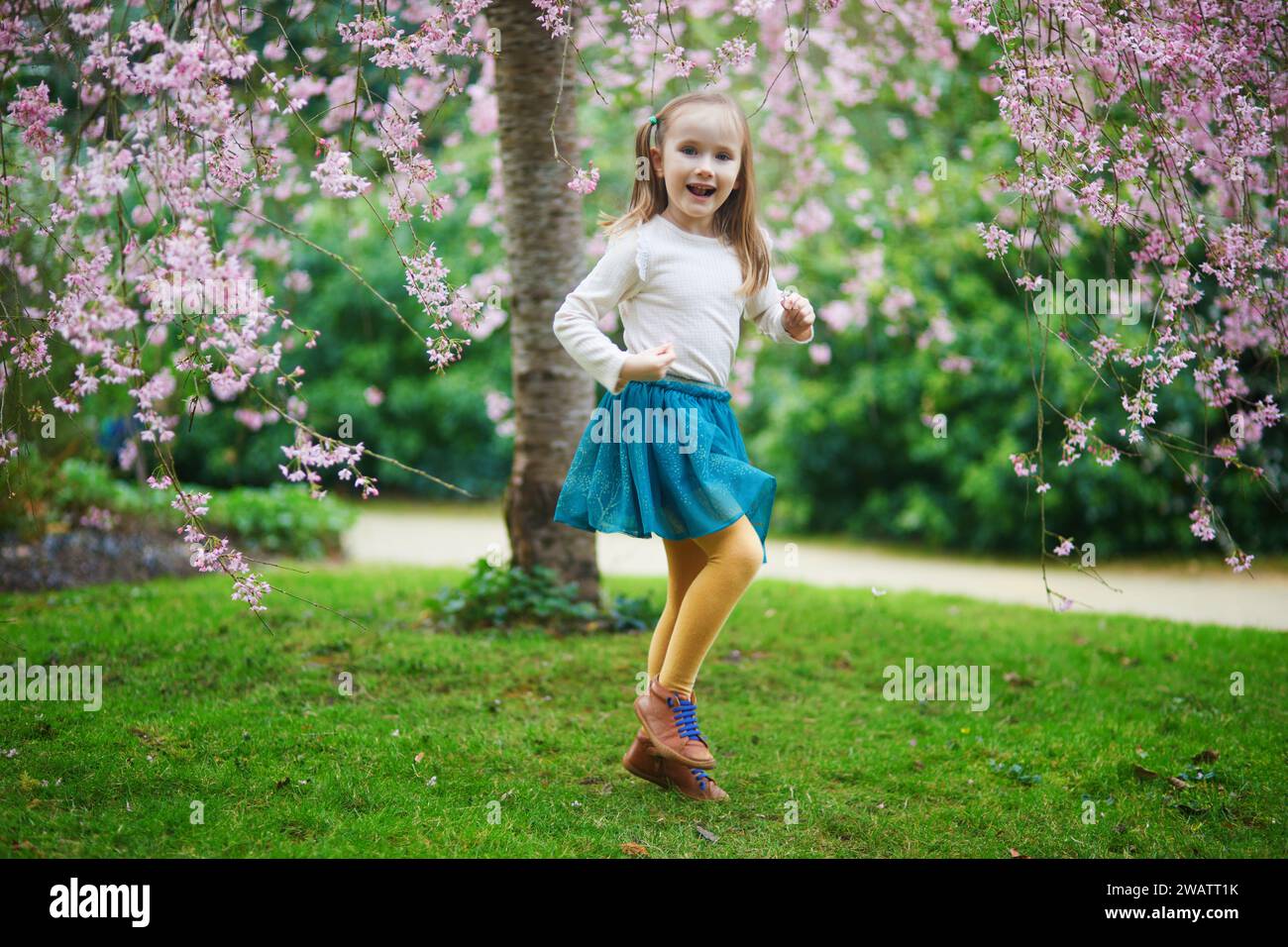 Adorable preschooler girl enjoying nice spring day in park during ...