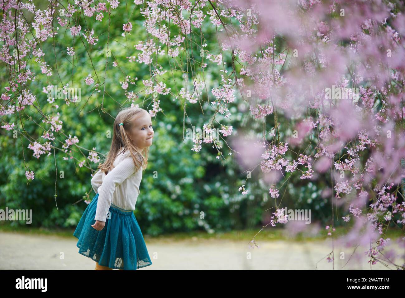 Adorable preschooler girl enjoying nice spring day in park during ...
