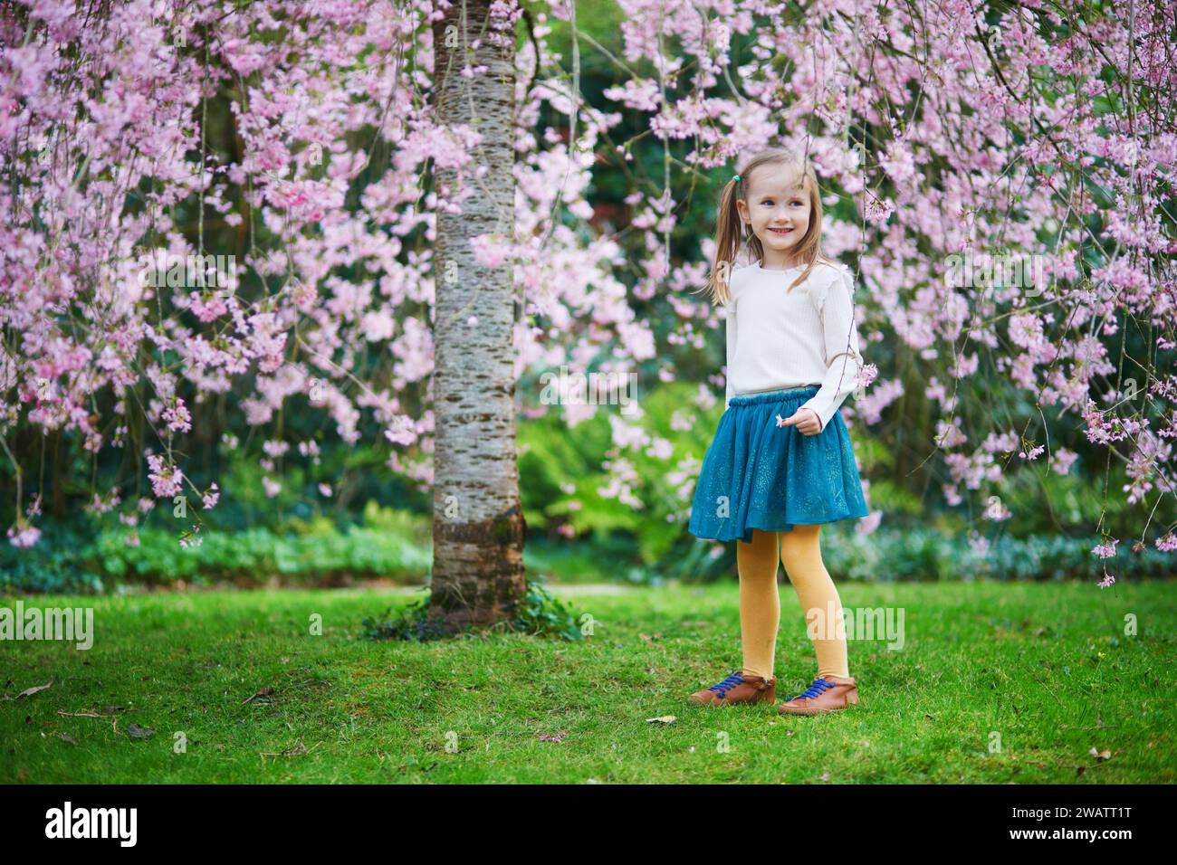 Adorable preschooler girl enjoying nice spring day in park during ...
