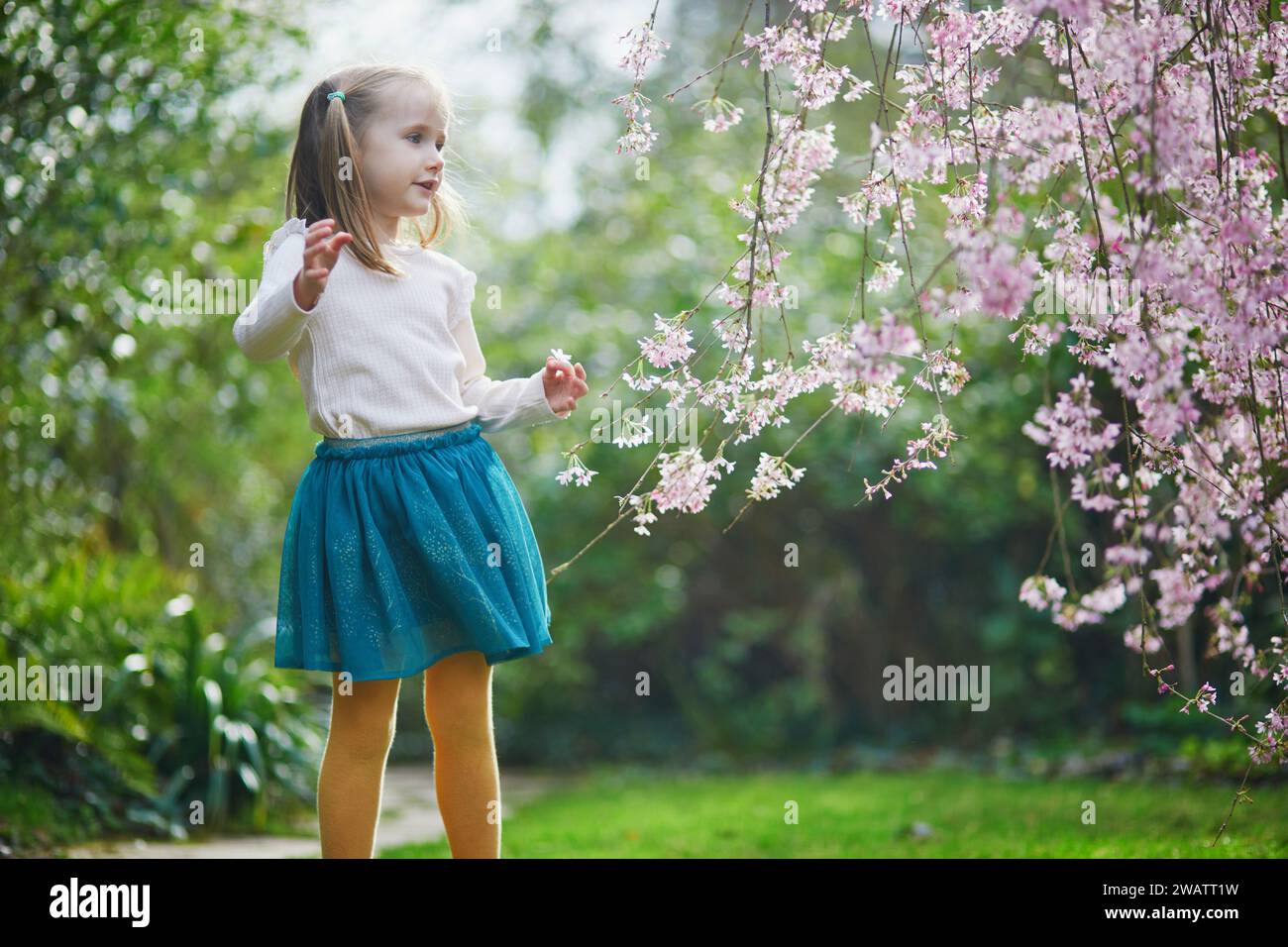 Adorable preschooler girl enjoying nice spring day in park during ...