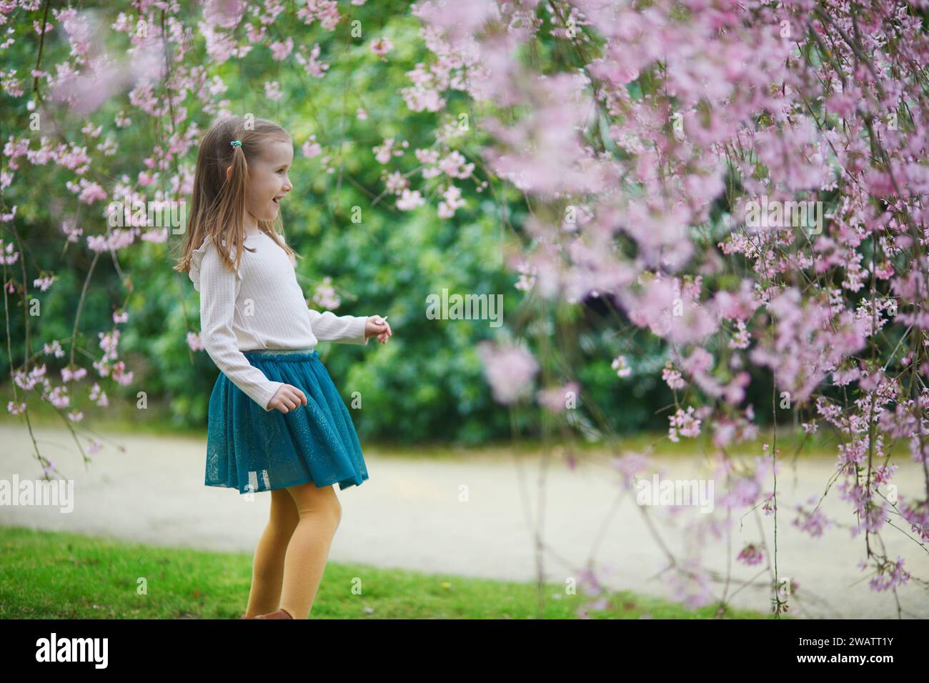 Adorable preschooler girl enjoying nice spring day in park during ...