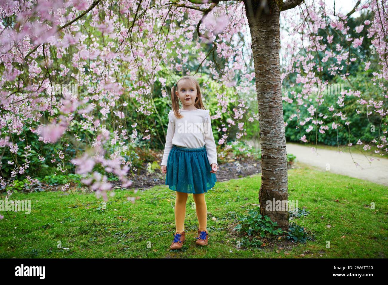 Adorable preschooler girl enjoying nice spring day in park during ...