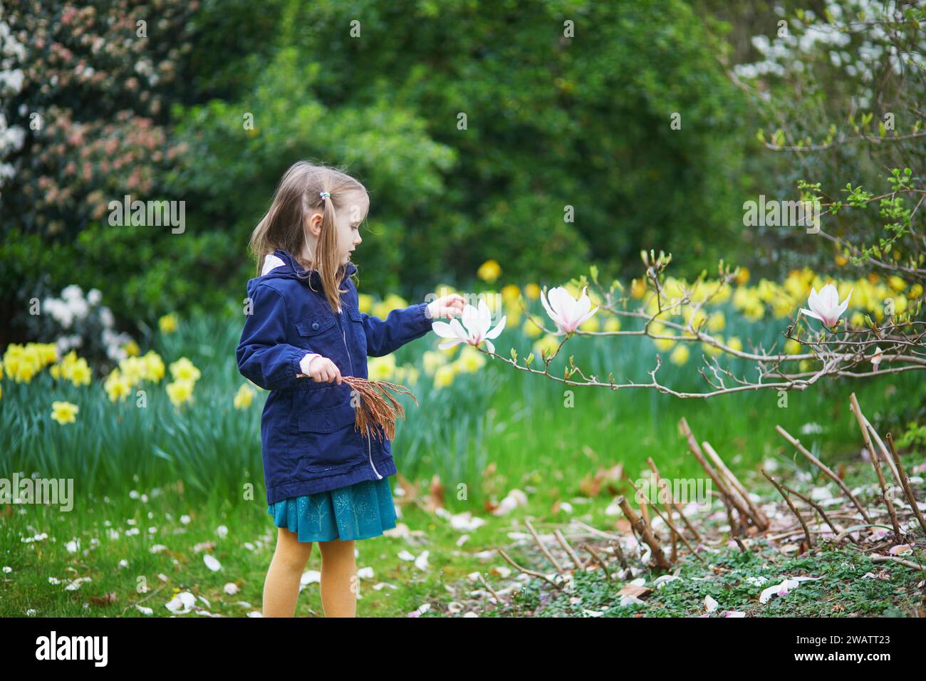 Adorable preschooler girl enjoying nice spring day in park during ...