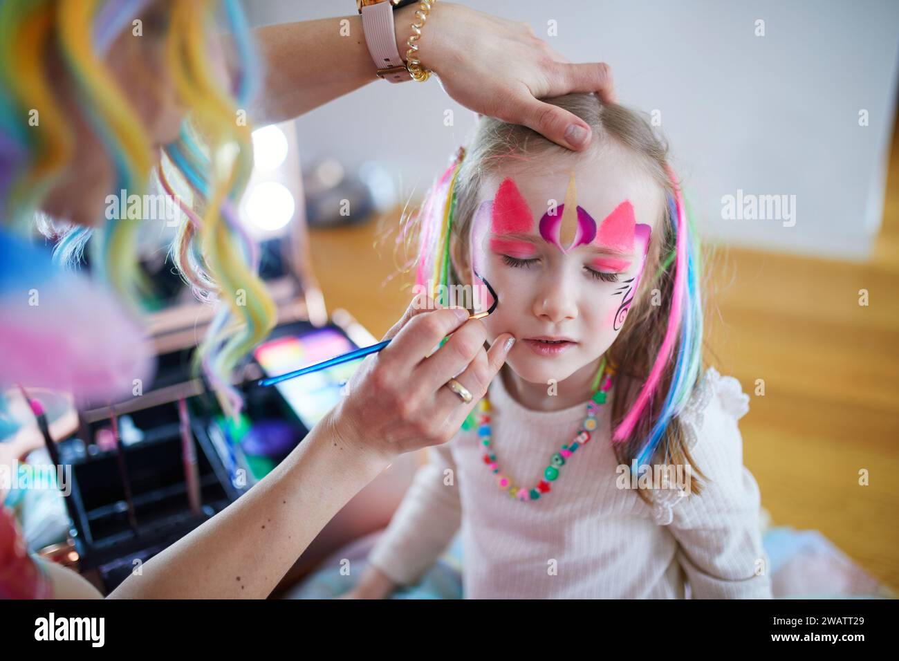 Children face painting. Artist painting little preschooler girl like ...