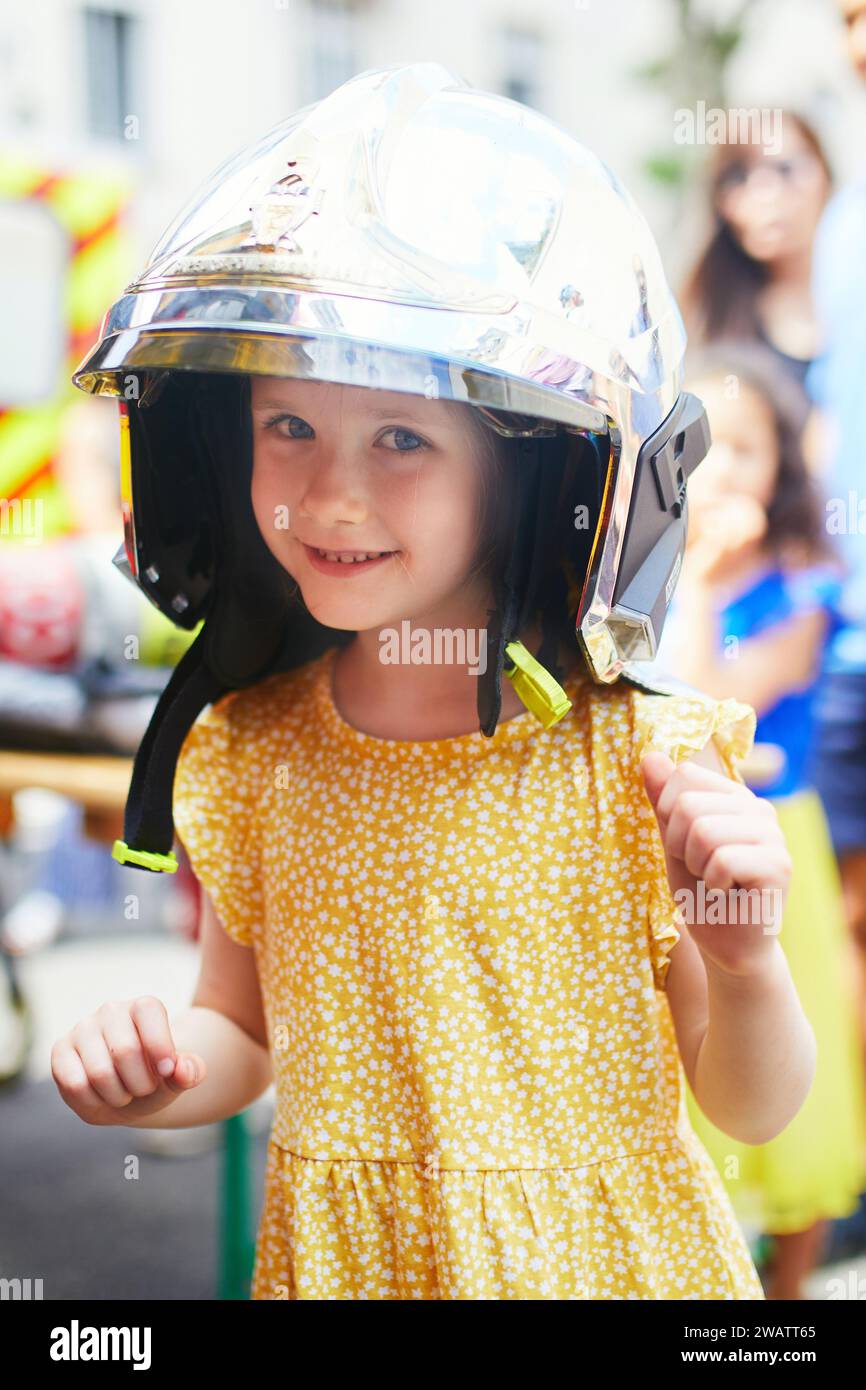 Adorable preschooler girl acting like a fireman and wearing a ...