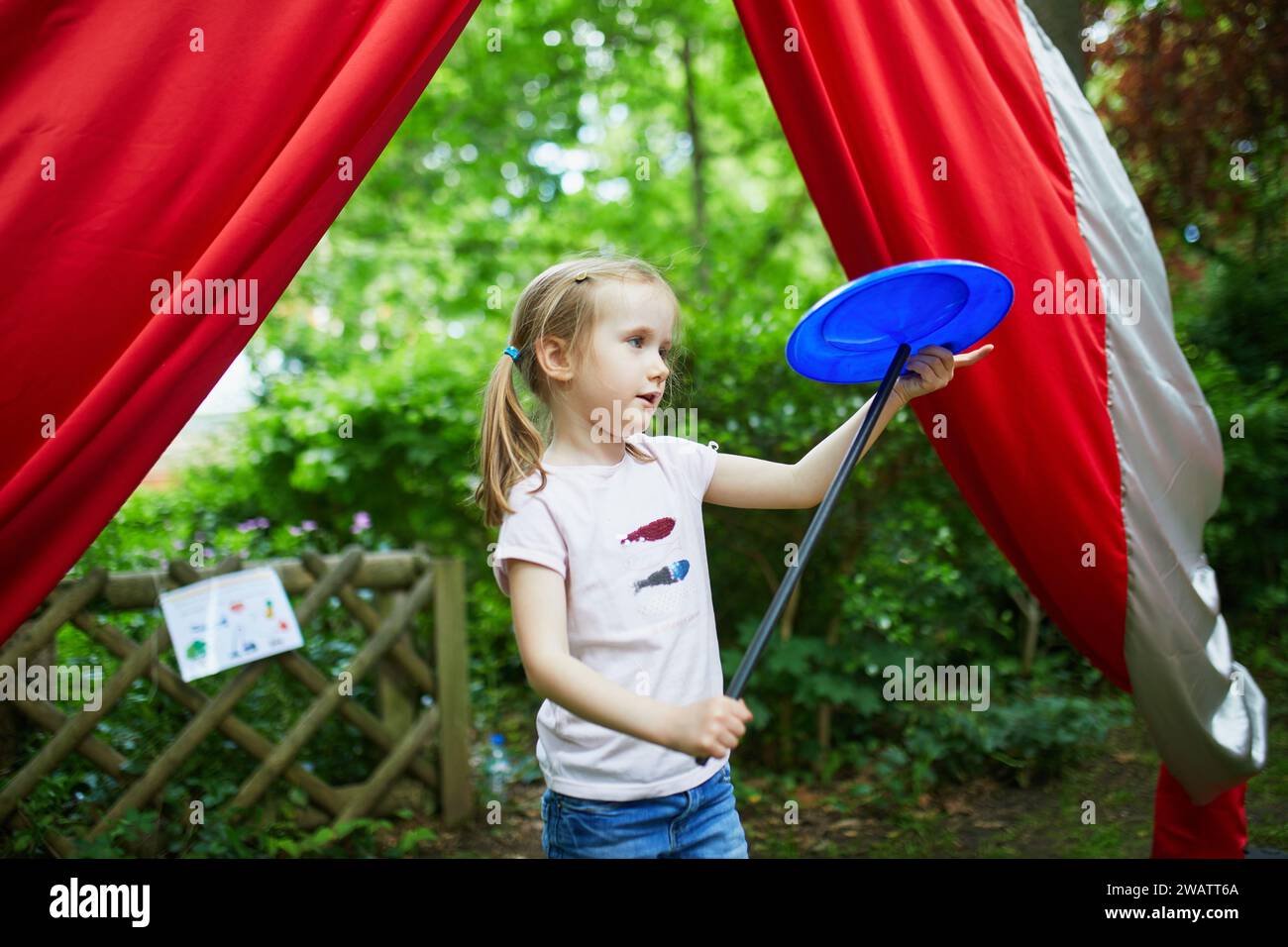 Preschooler girl practicing spinning circus skills outdoors Stock Photo ...
