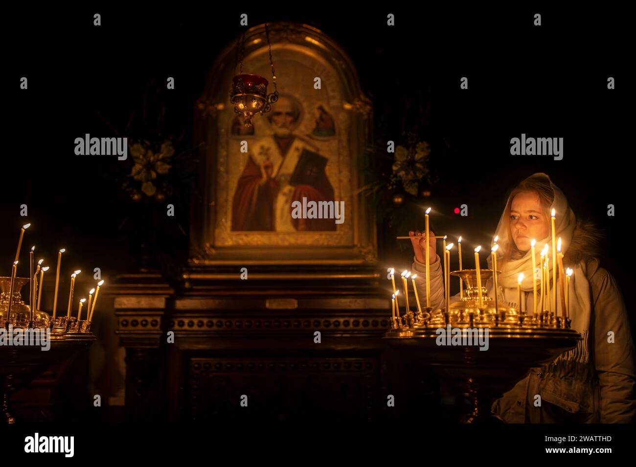 A Lithuanian Orthodox worshipper lights candles before the liturgy on ...