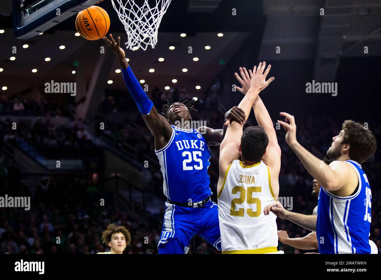 Duke's Mark Mitchell shoots next to Notre Dame's Matt Zona (25) as Duke ...