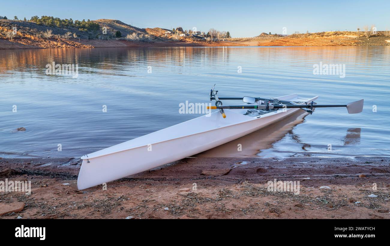 Coastal rowing shell on a shore of Horsetooth Reservoir in fall or ...