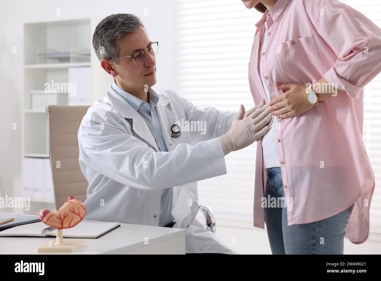 Gastroenterologist examining patient with stomach pain in clinic Stock ...