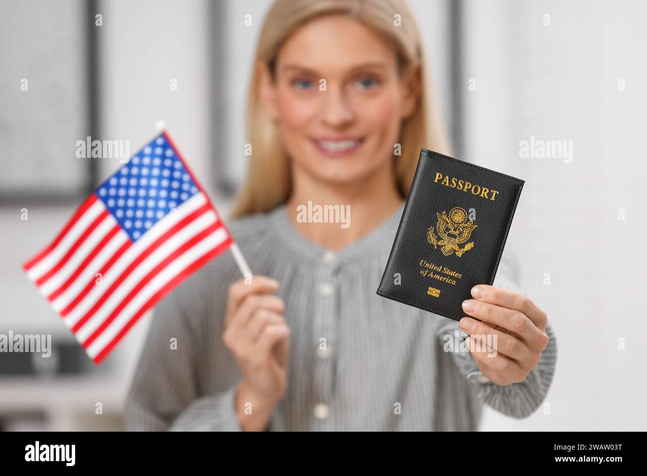 Immigration. Happy woman with passport and American flag indoors ...