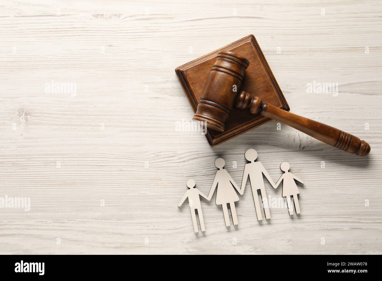Law concept. Gavel and figures of parents with children on white wooden ...