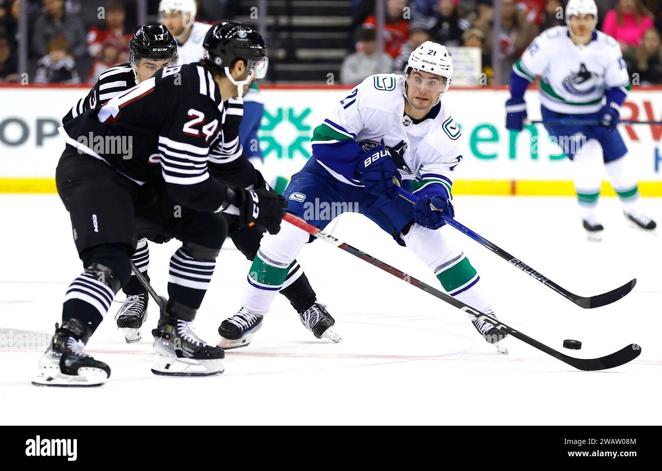 Vancouver Canucks left wing Nils Hoglander (21) passes the puck against ...