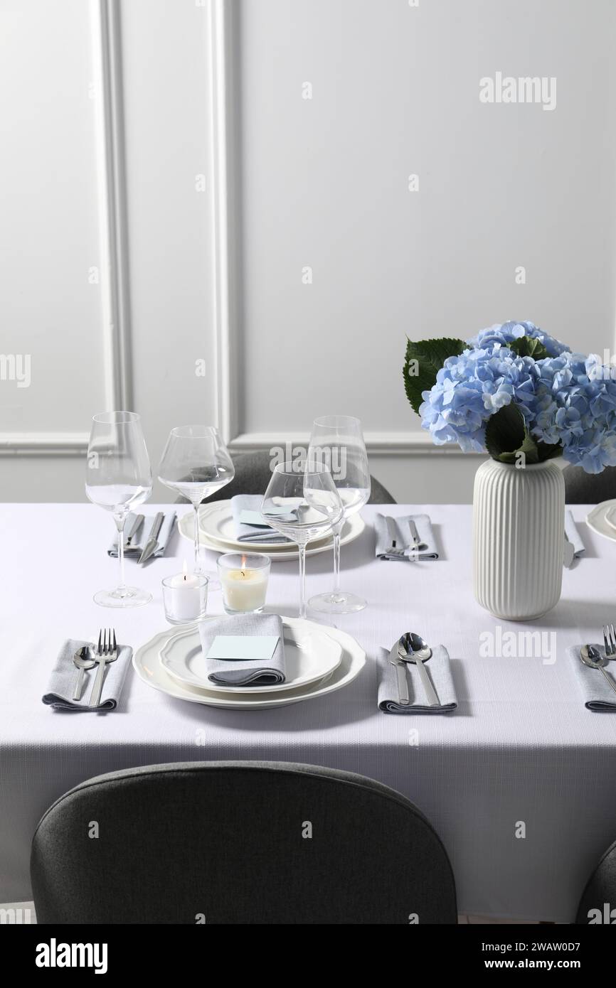 Beautiful table setting with cards and floral decor indoors Stock Photo ...