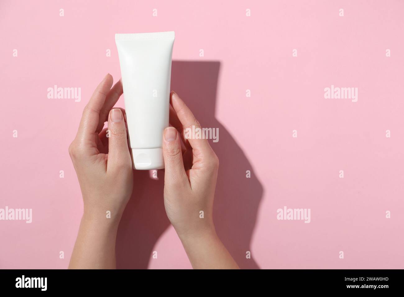 Woman With Tube Of Hand Cream On Pink Background Top View Space For woman-with-tube-of-hand-cream-on-pink-background-top-view-space-for