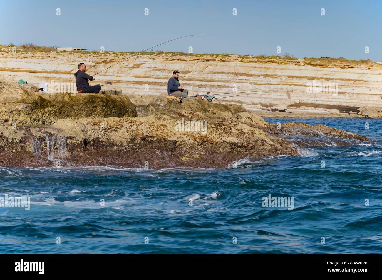 Fisherman at Kalanka Bay in Marsaxlokk, Malta Stock Photo - Alamy