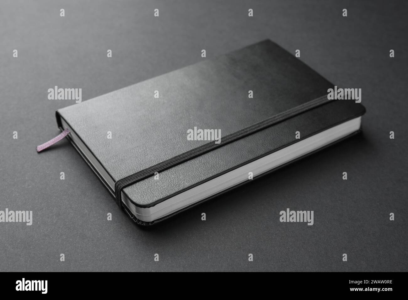 Closed notebook with blank cover on black background Stock Photo - Alamy